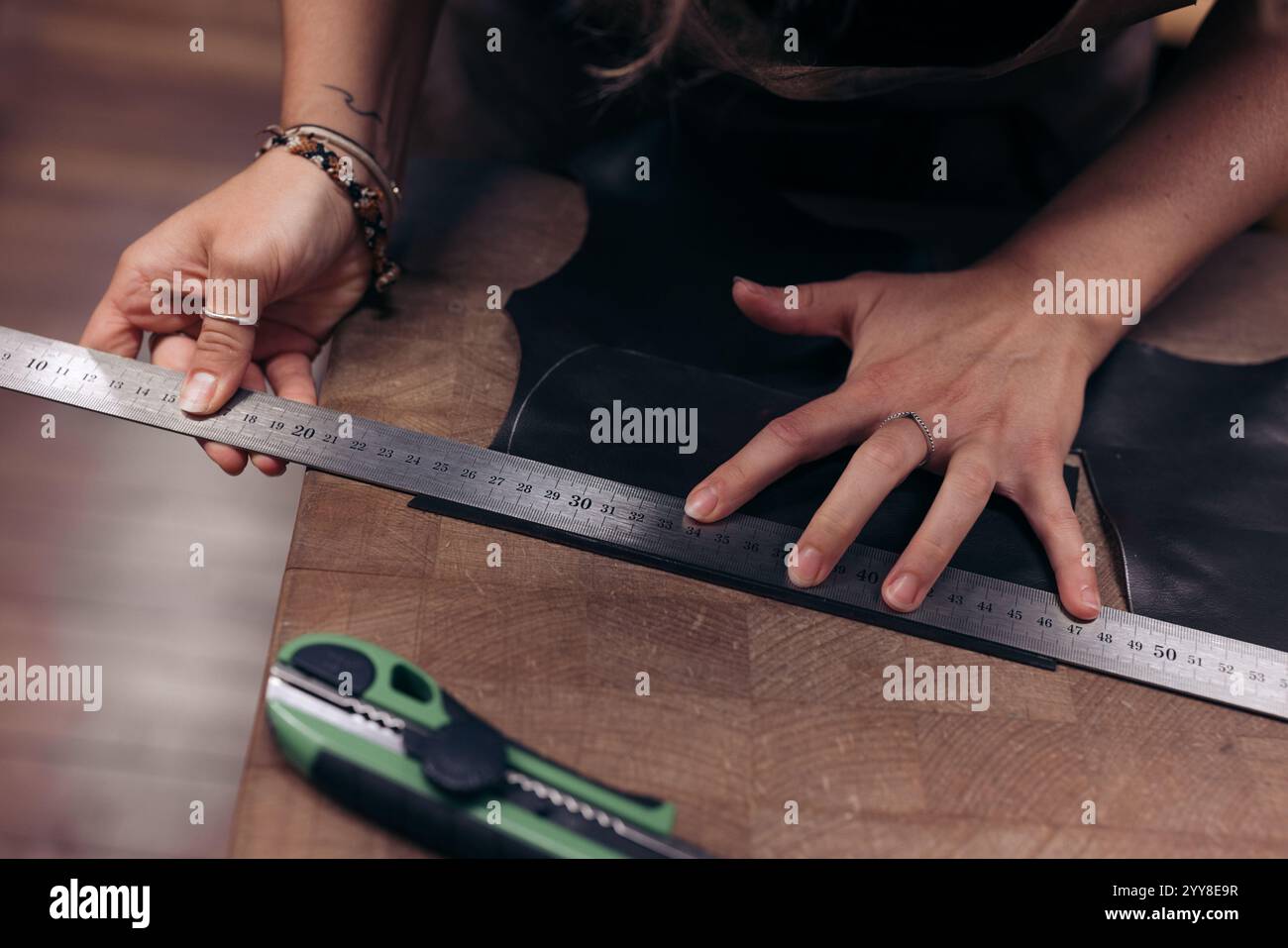 Leatherworker measuring cutting leather hi-res stock photography and ...
