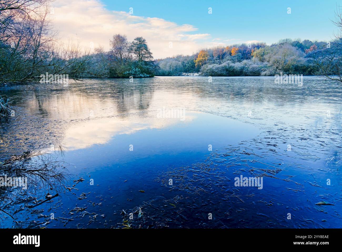 Ice begins to form on the surface of Mill Lake as the temperature drops ...