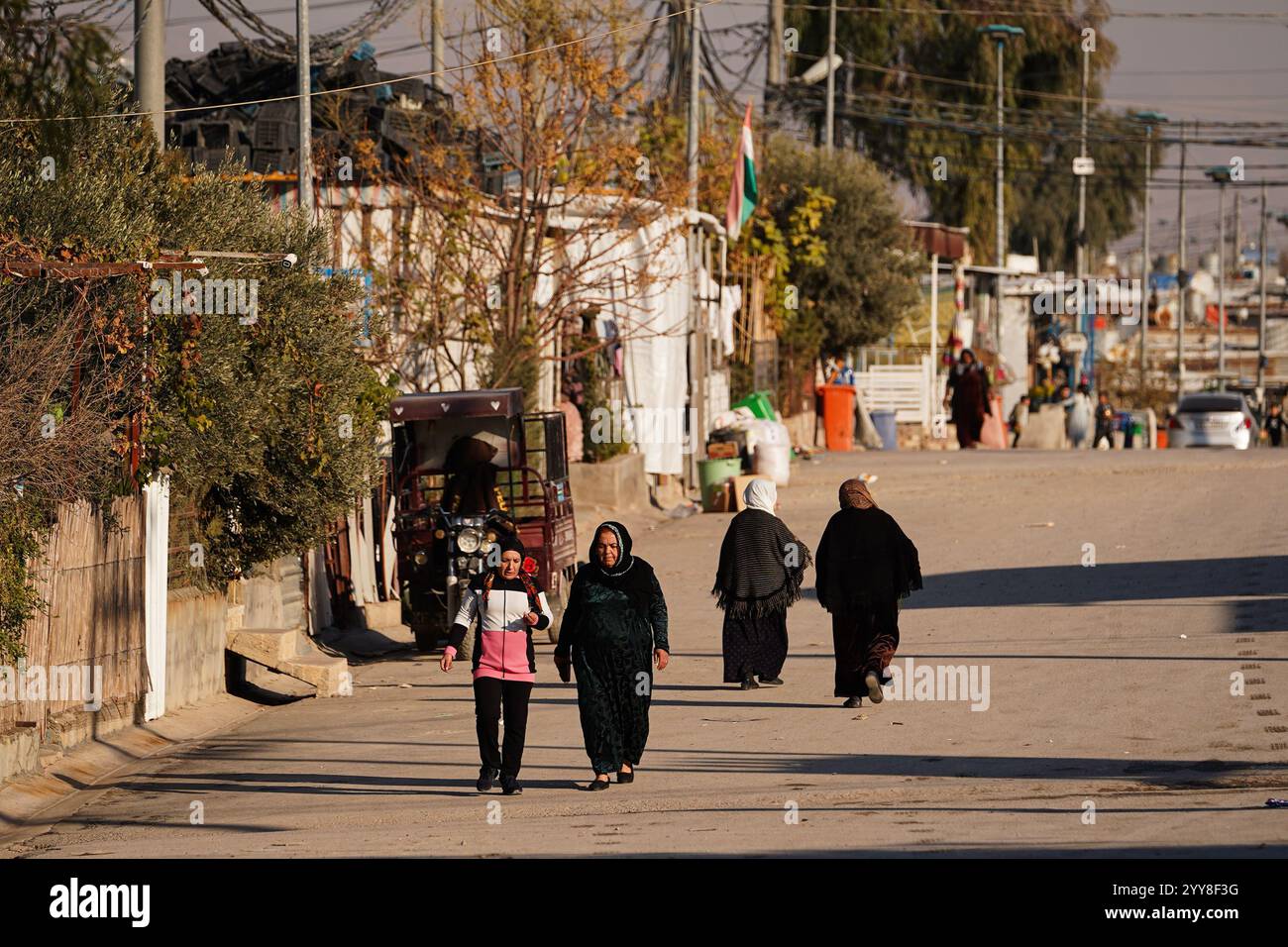 People walk in the street at Domiz camp for Syrian Kurdish refugees ...