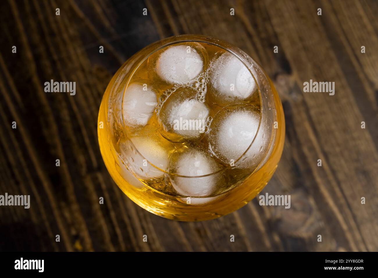 ice and yellow juice , transparent glass with cold apple juice with ice ...