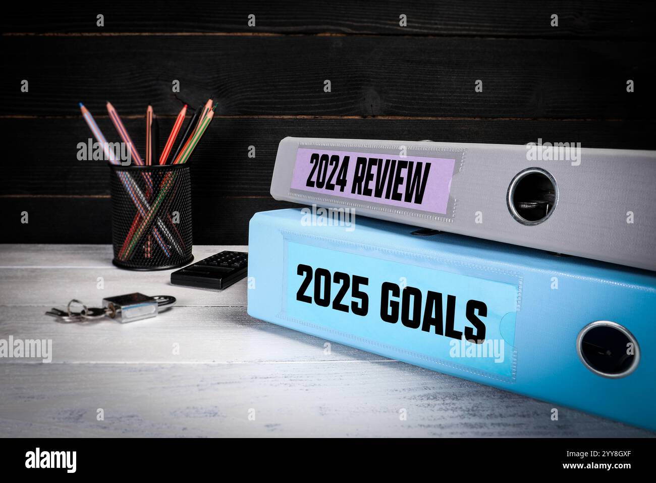 2024 Review and 2025 Goals. Two binders on desk in the office. Business ...