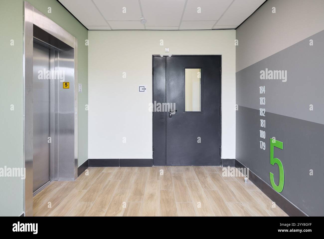 Modern elevator lobby design with numbered floor indicators for ...