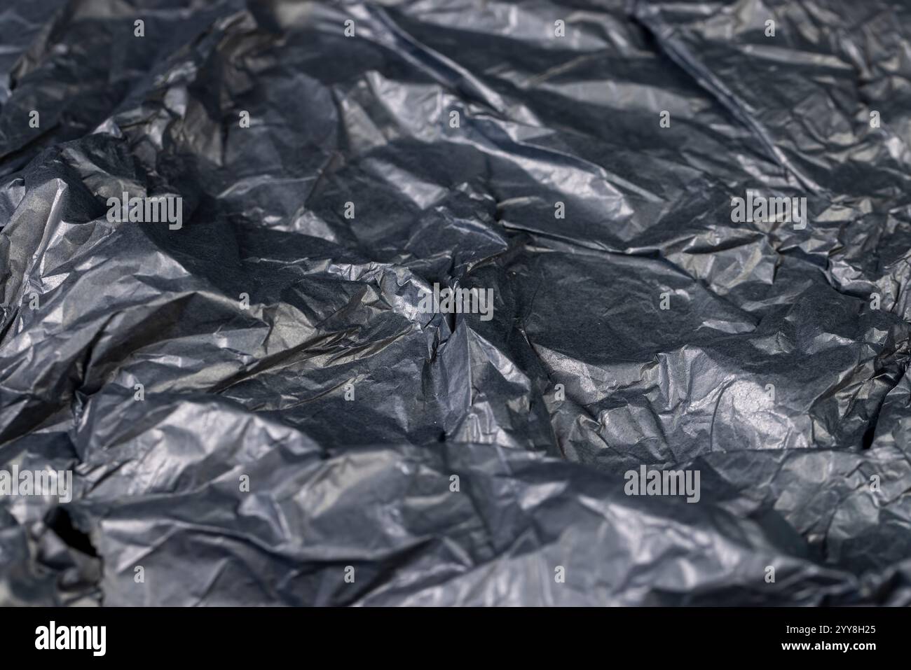 crumpled wrapping paper in closeup, a piece of black paper for ...