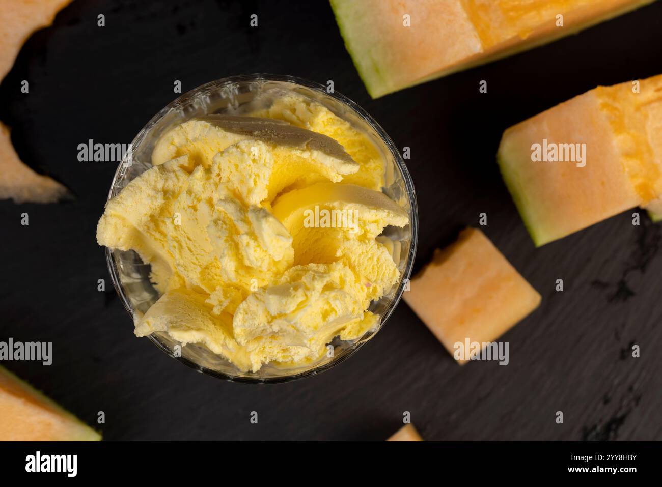 melon flavored ice cream and melon cut into pieces close up, sweet ...