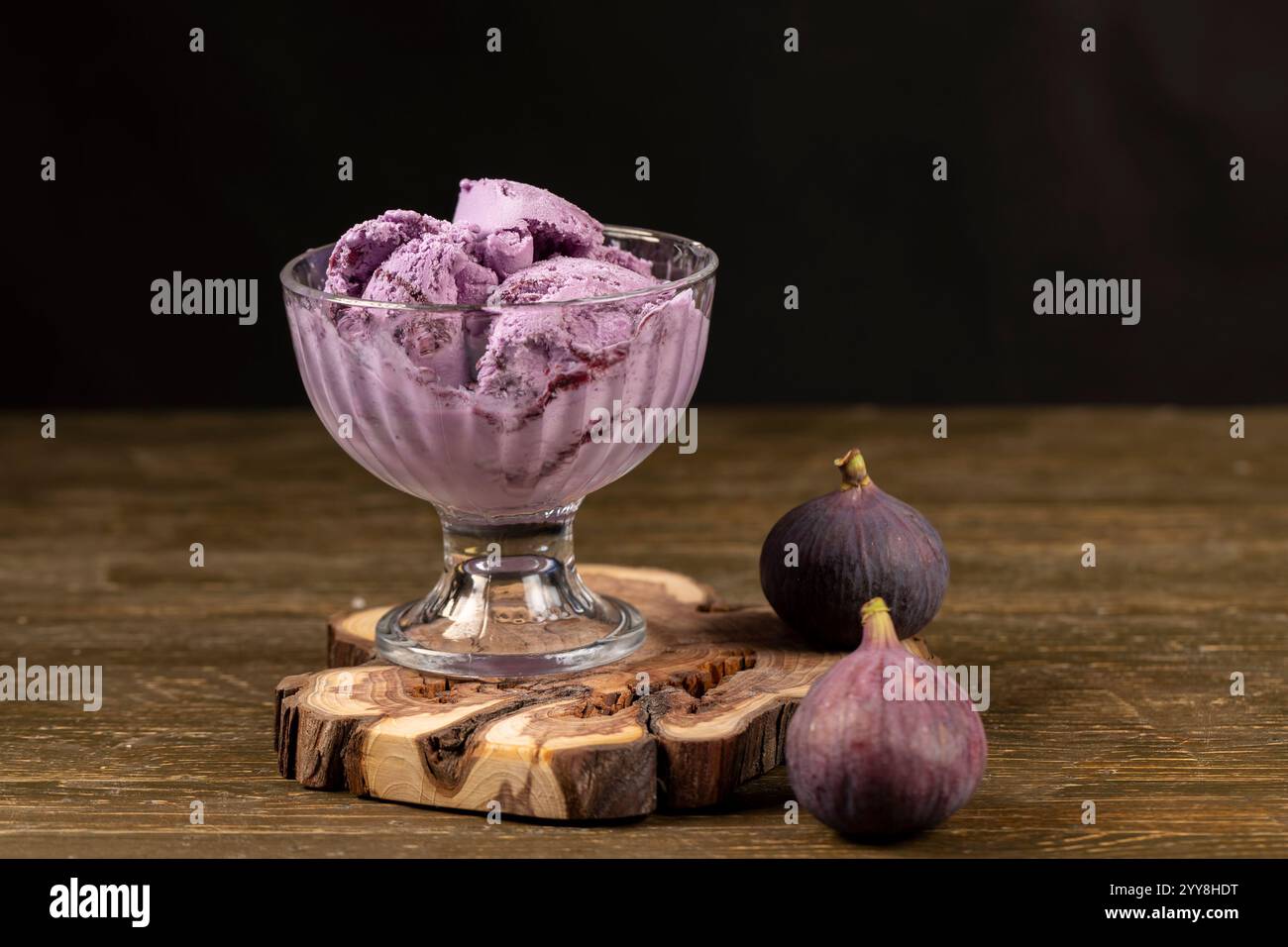 sweet fig-flavored ice cream and ripe purple figs on the table, purple ...