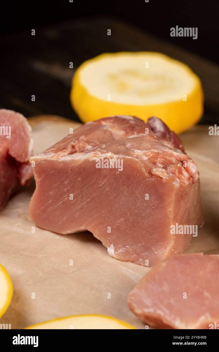 a cut piece of pork fillet on a cutting board, sliced high-quality pork ...