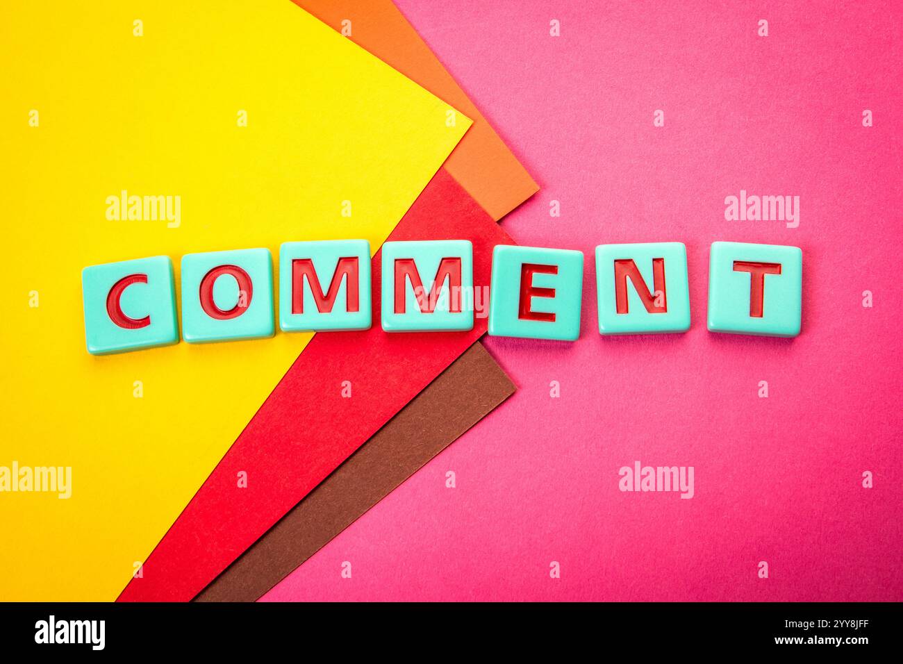 COMMENT. Alphabet letter tiles on a red textured background Stock Photo ...