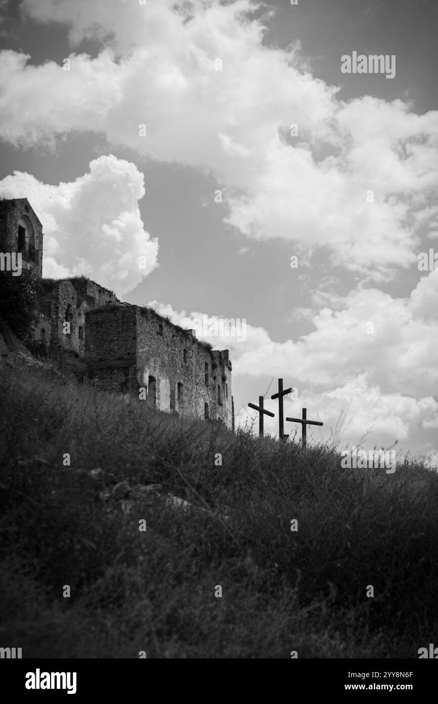 Dramatic black-and-white view of three crosses on a hillside next to an ...