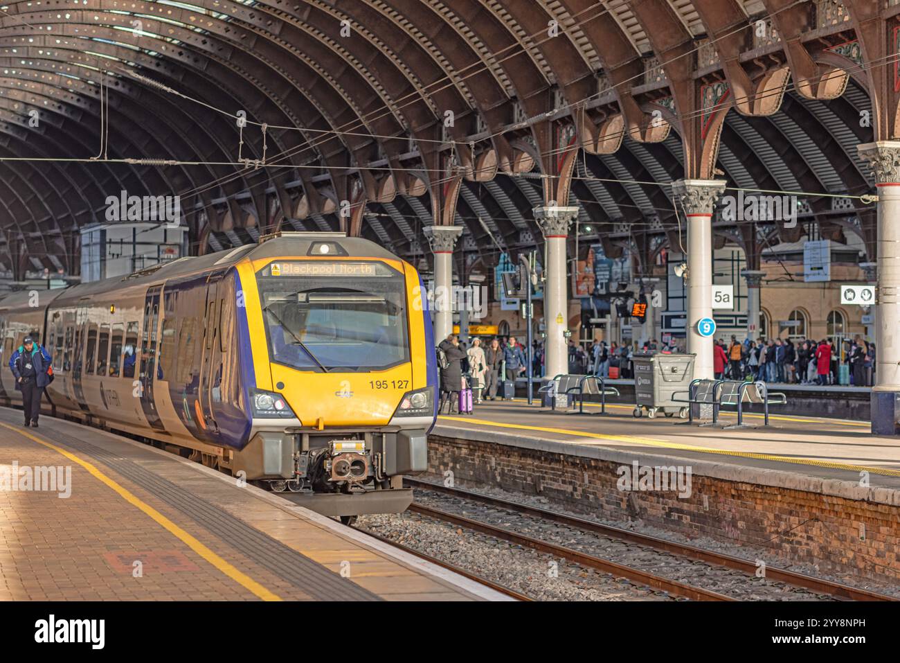 A railway train locomotive stands at a station platform. A historic ...