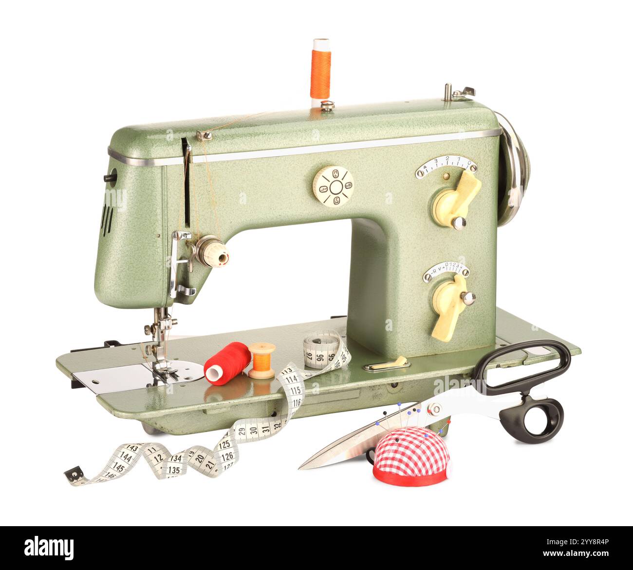 Sewing machine, measuring tape, scissors, pincushion and spools of ...