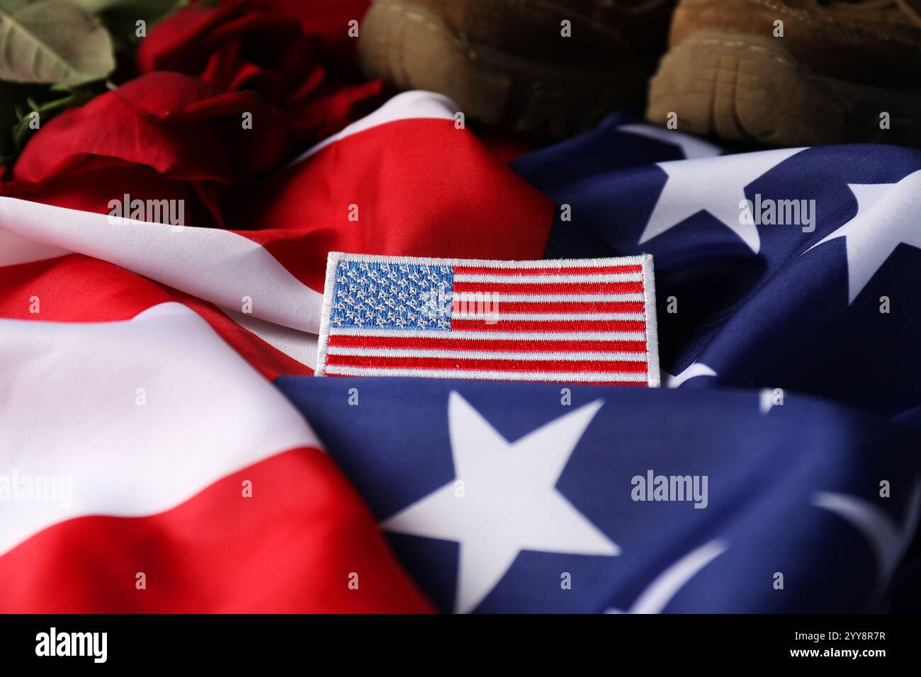 Veterans day. USA army patch, American flag, roses and military shoes ...