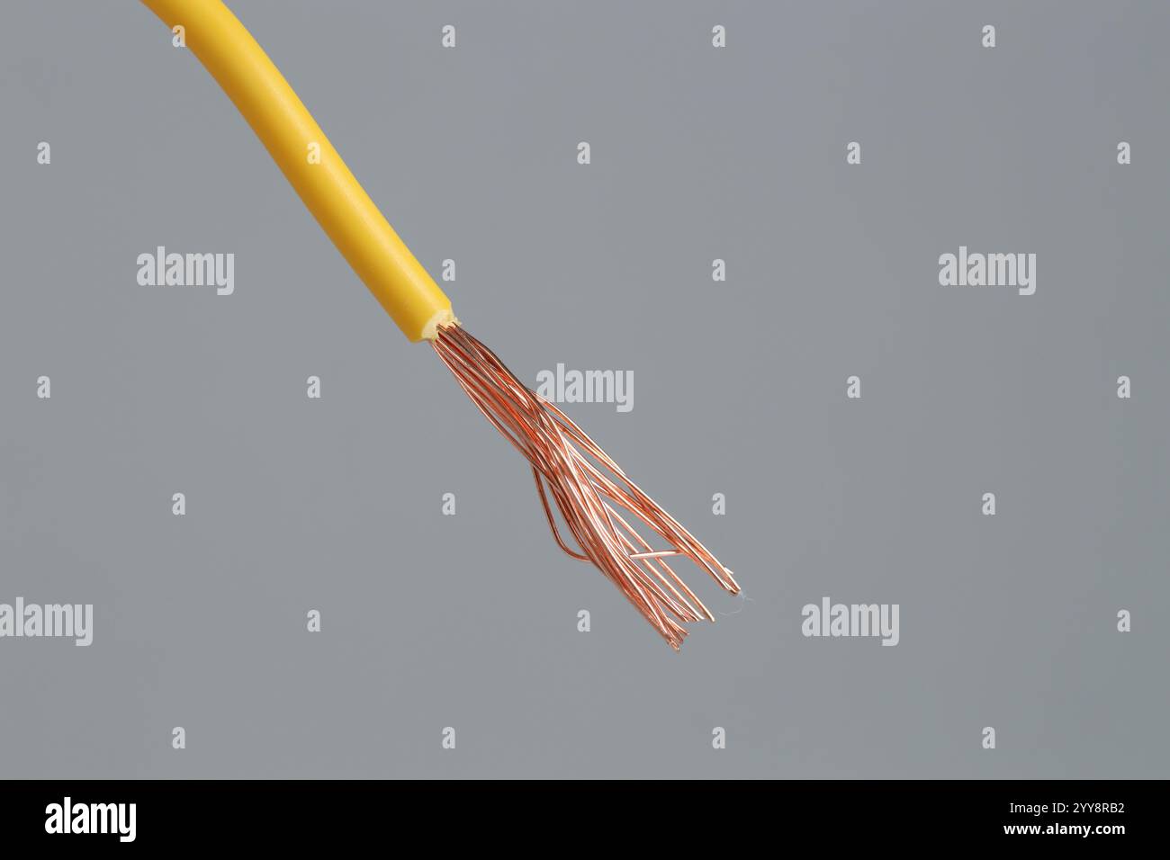 Yellow stripped electrical wire on light grey background, closeup Stock ...