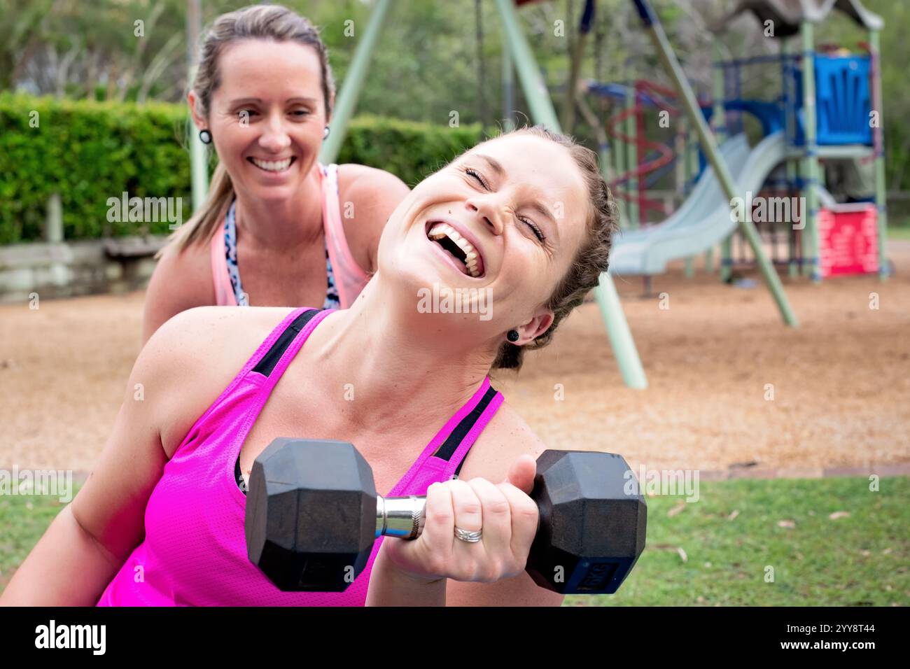 fitness fun, two women exercising outdoors, lifting weights, laughing, busy mother mom mum ...
