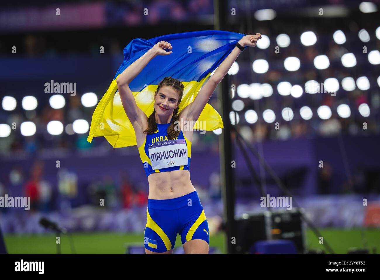 Yaroslava Mahuchikh celebrating her medal with her country's flag at ...