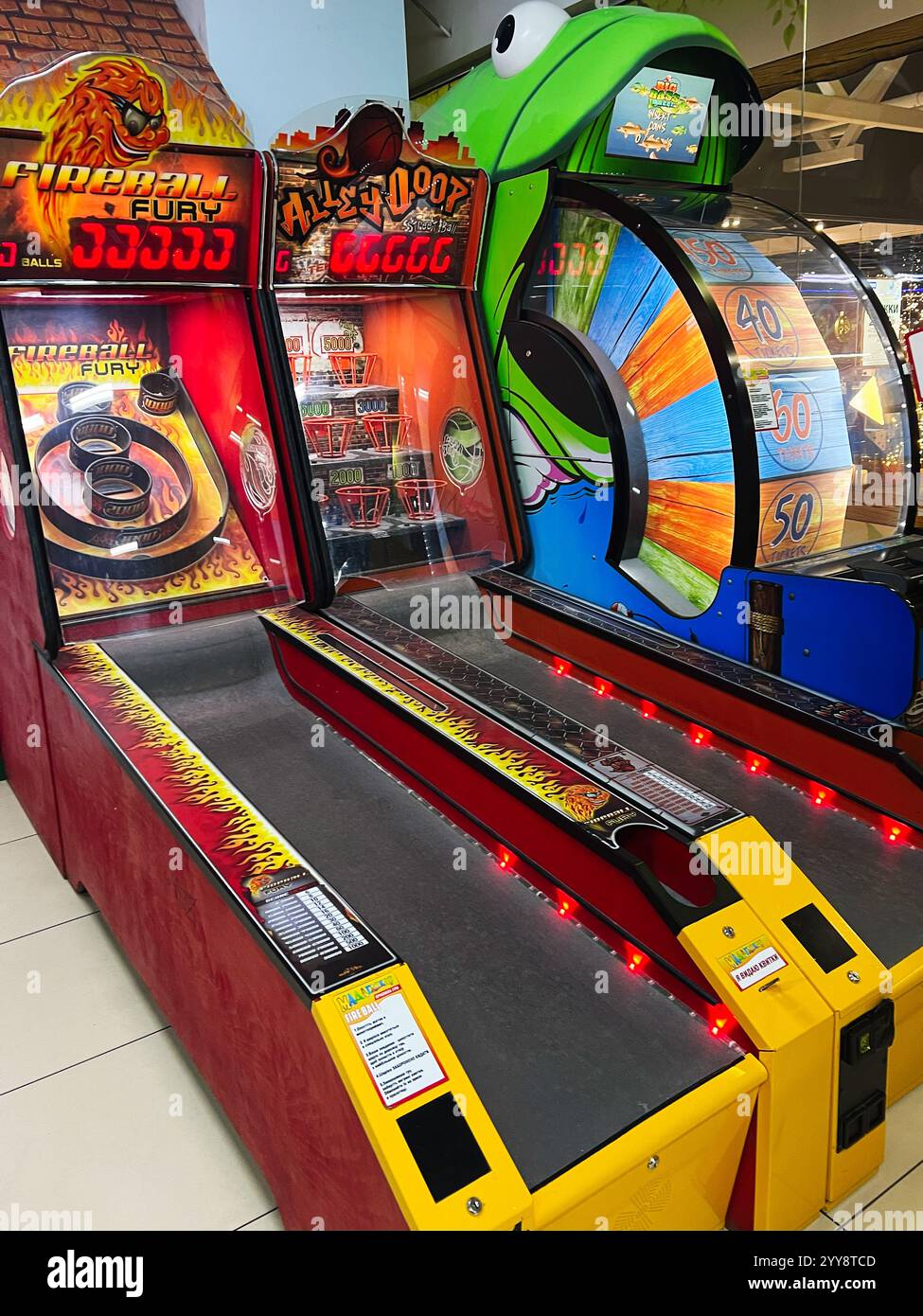 Kyiv, Ukraine - December 18, 2024: Colorful arcade machines featuring basketball hoops, rolling ...