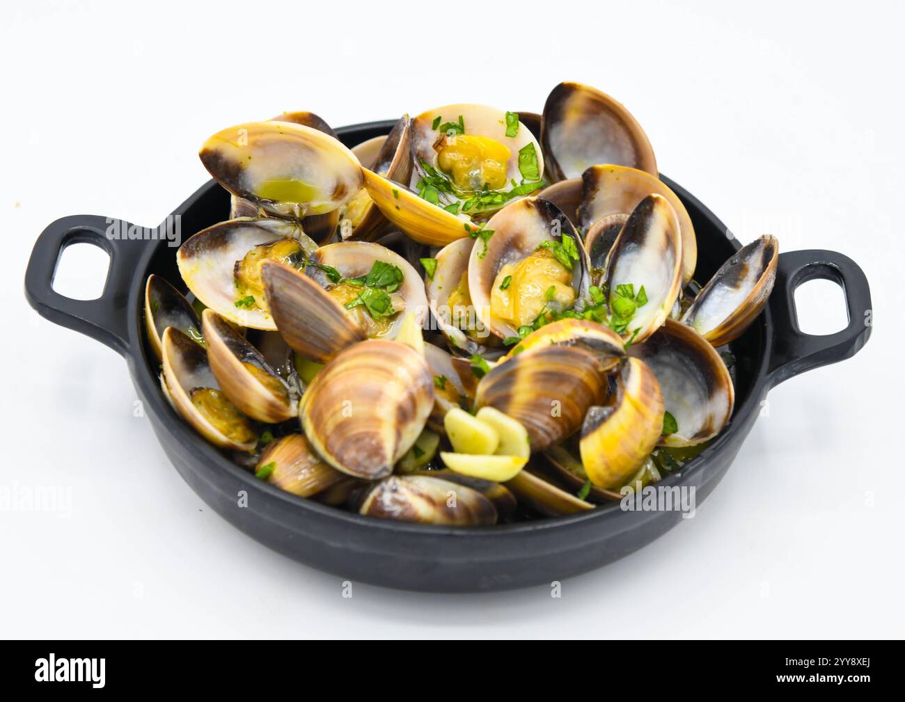 Clams cooked in a pan with parsley on a white background Stock Photo ...