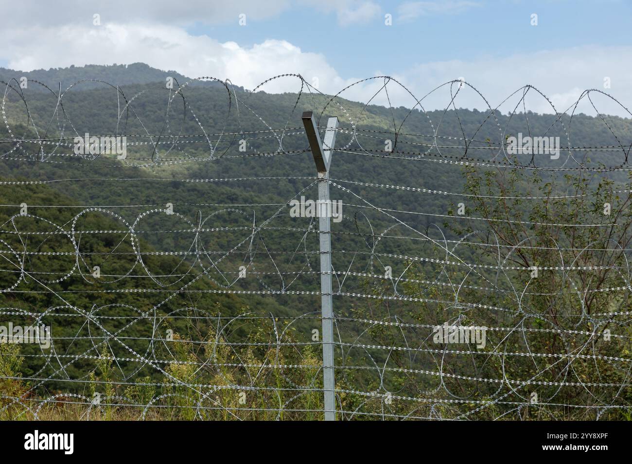 A barbed wire fence marks the border between Iran and Azerbaijan. The ...