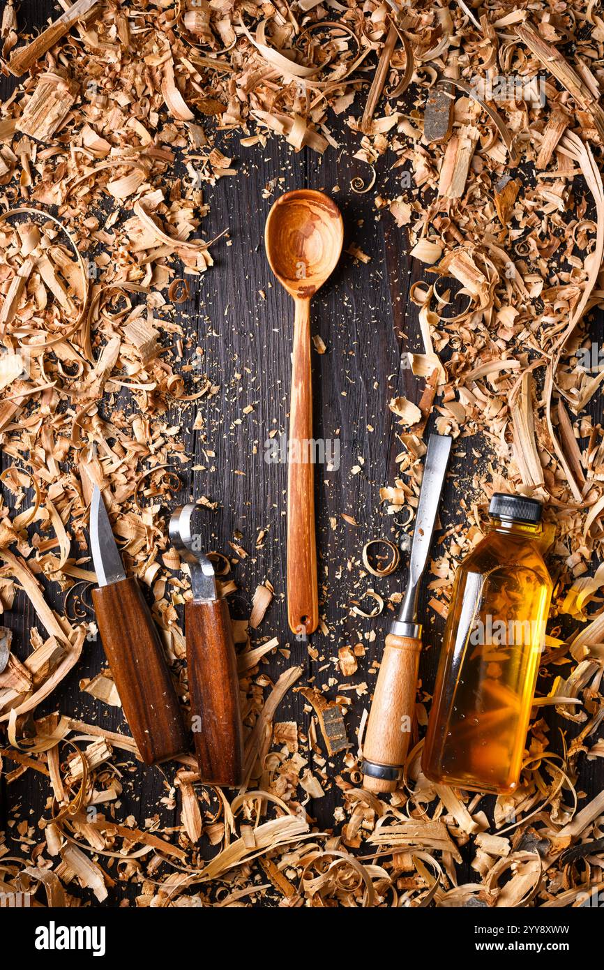 Cozy handcrafted wooden spoon with heap of wooden filings with hand ...