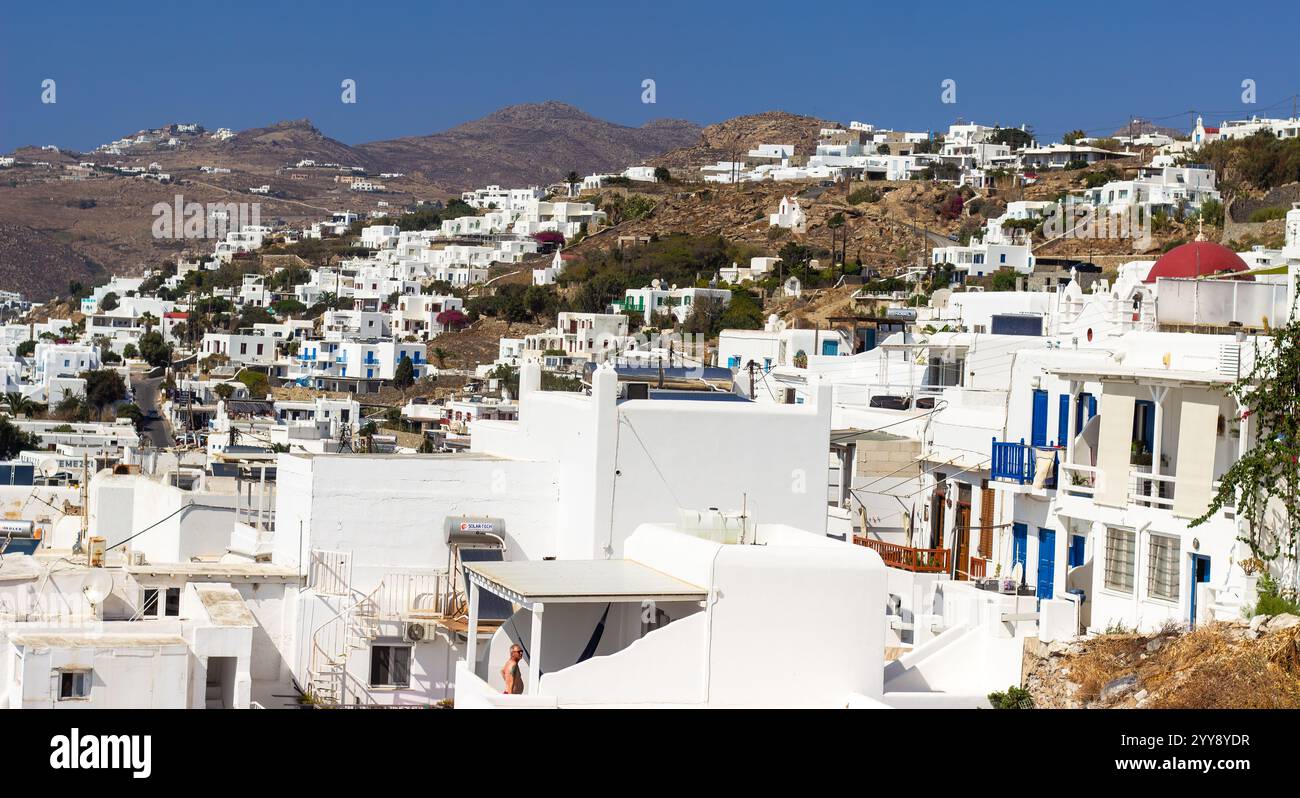 Whitewashed buildings of Mykonos town overlooking the Aegean Sea under ...