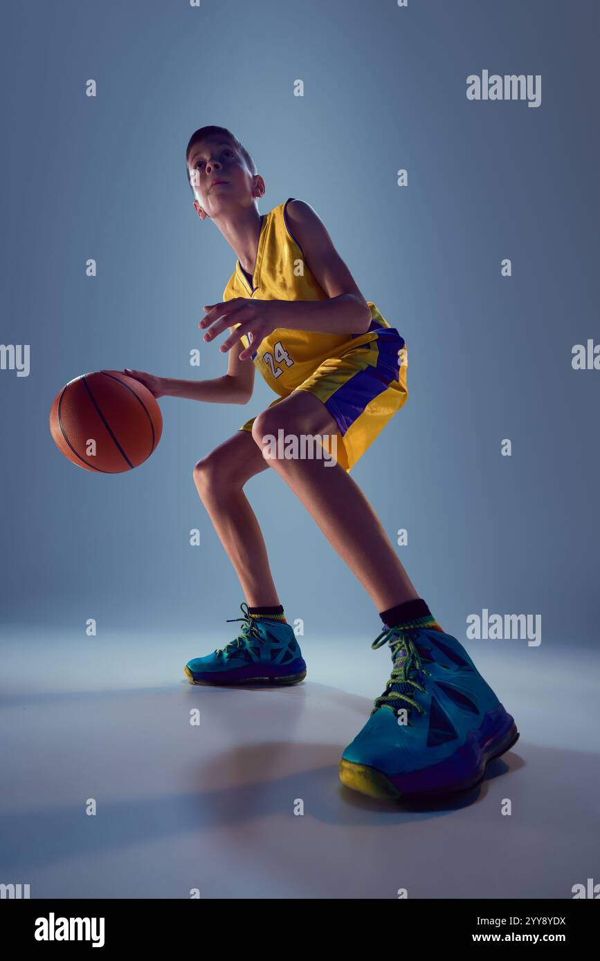 Low angle view of confident junior basketball athlete playing ...