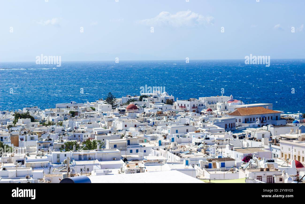 Whitewashed buildings of Mykonos town overlooking the Aegean Sea under ...