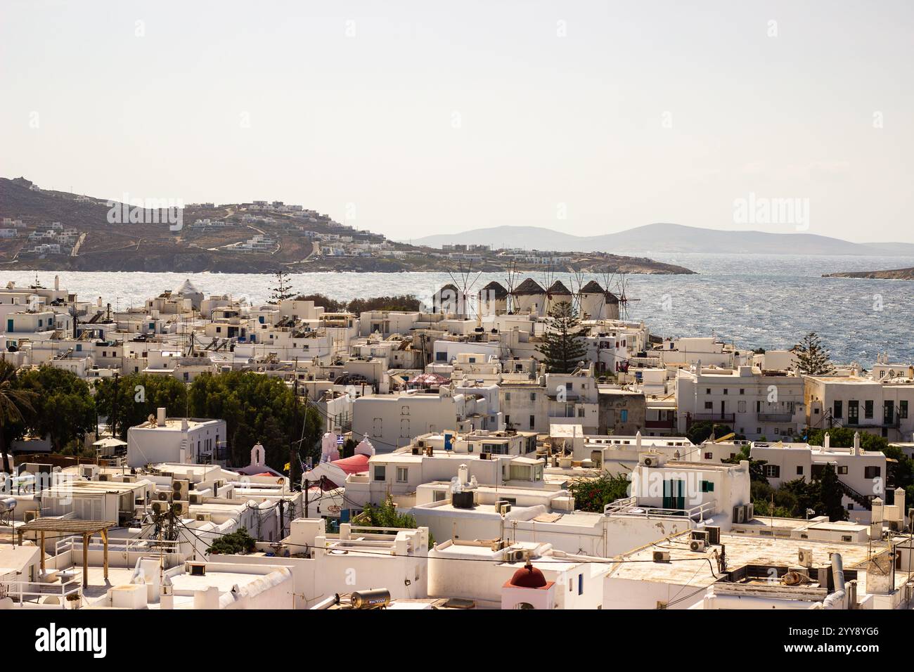 Whitewashed buildings of Mykonos town overlooking the Aegean Sea under ...