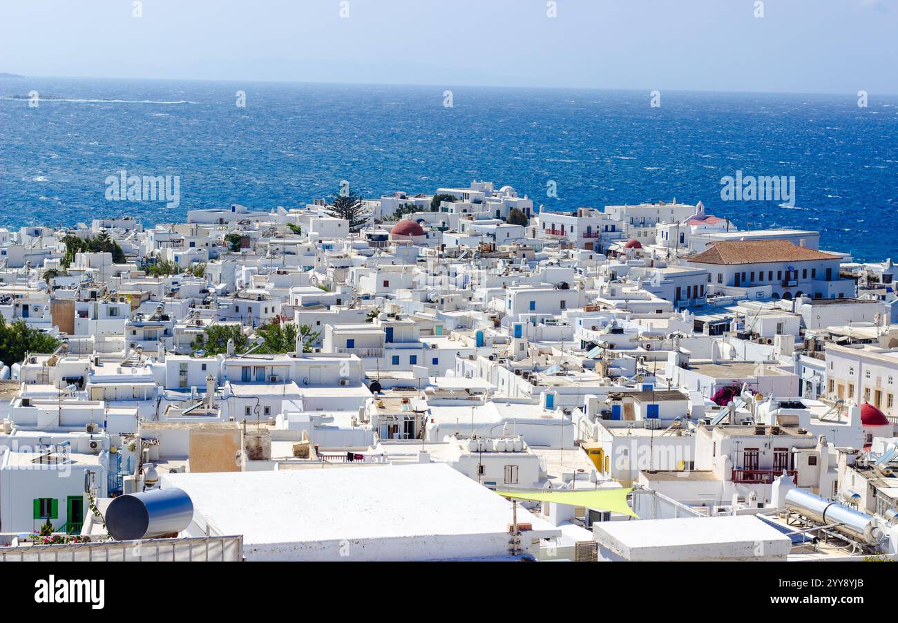 Whitewashed buildings of Mykonos town overlooking the Aegean Sea under ...