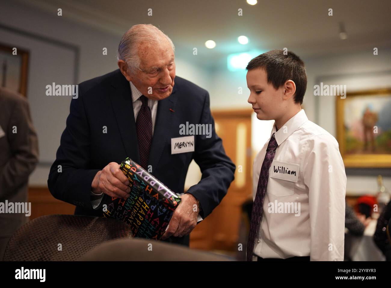 Normandy veteran Mervyn Kersh opens a gift from 10-year-old William ...