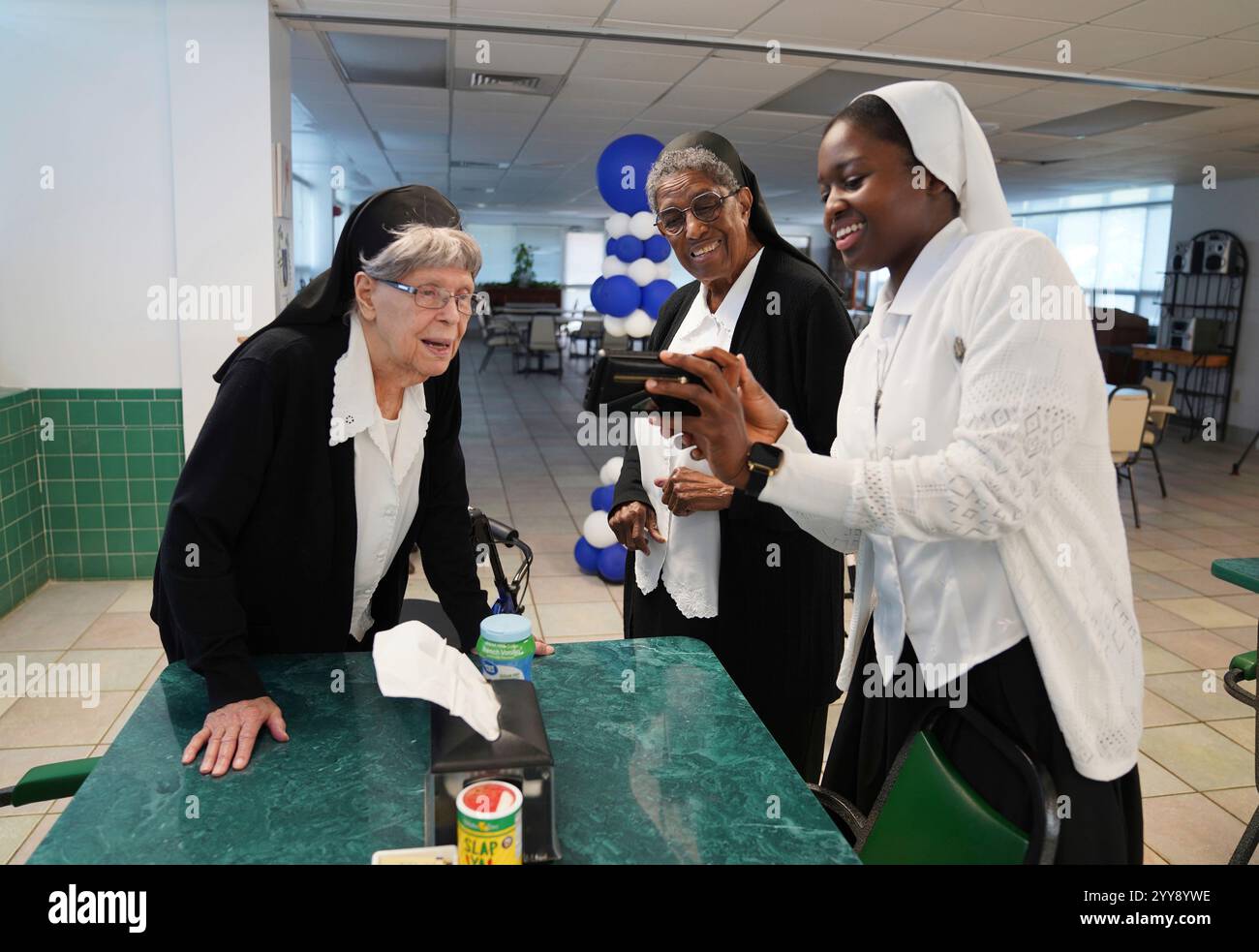 Sr. Ann Elise Sonnier, left, and Sister Clara Mae Jackson, center, look ...