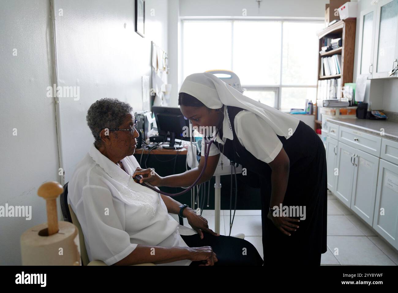 Sister Seyram Mary Adzokpa, right, listens to Sister Clara Mae Jackson ...