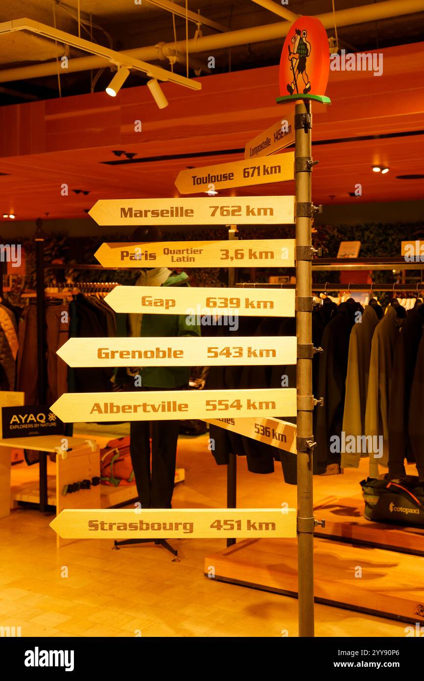 Directional signs display distances to various cities in a retail ...