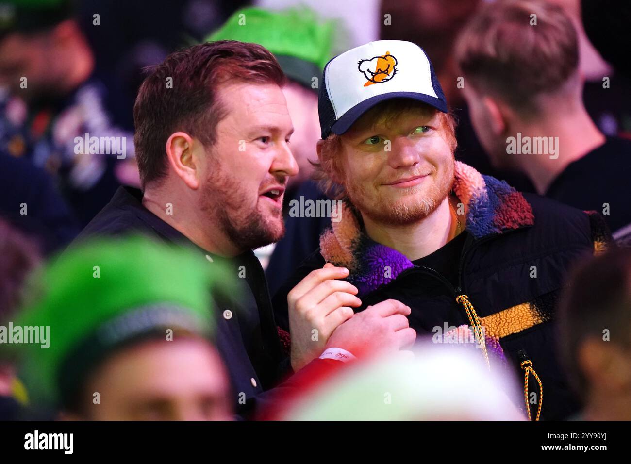 Singer songwriter Ed Sheeran (right) watches the action during day six ...