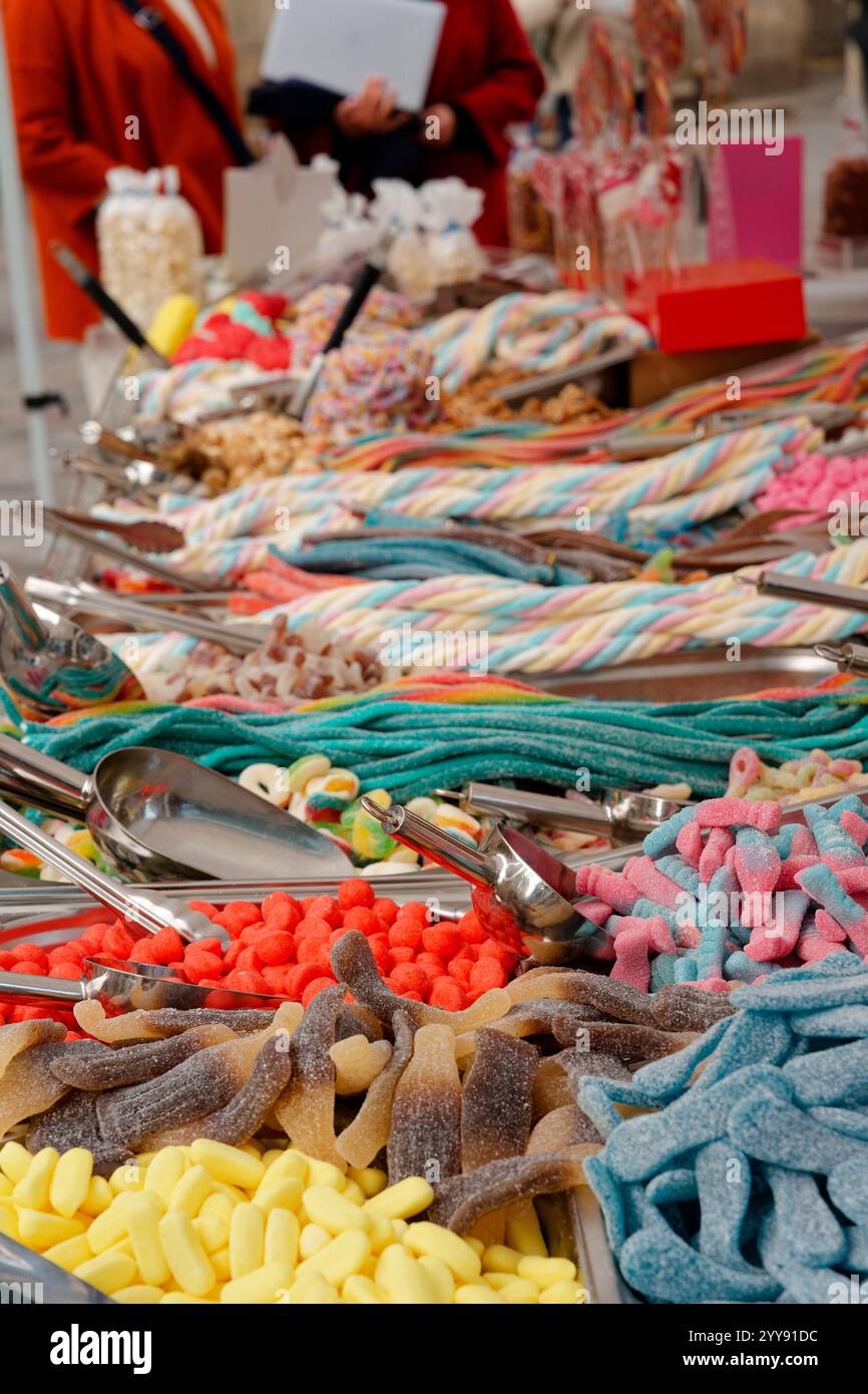Colorful candies and sweets displayed at a festive market stall in the ...