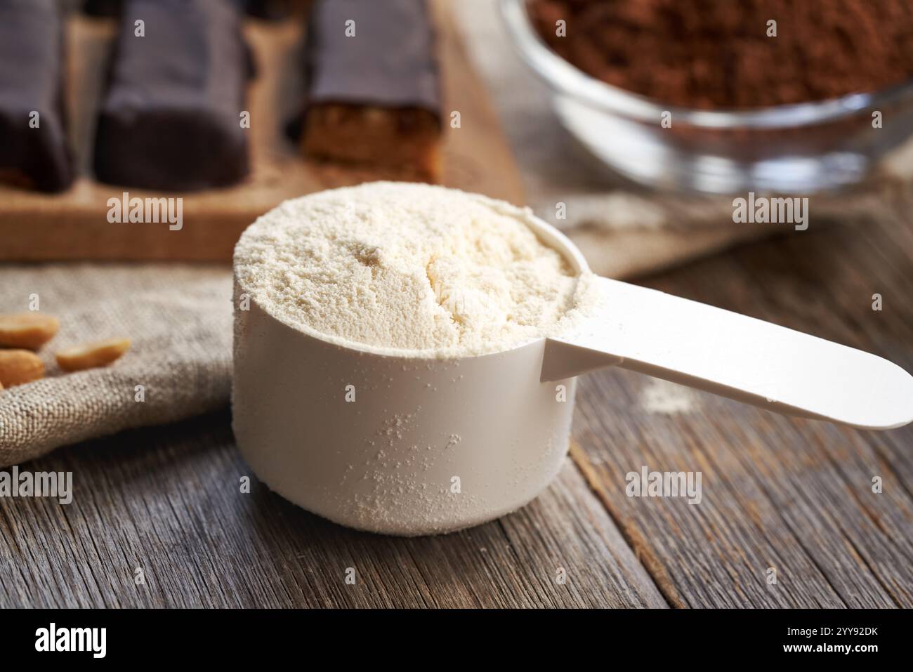 A scoop of whey protein powder with homemade no-bake healthy chocolate ...