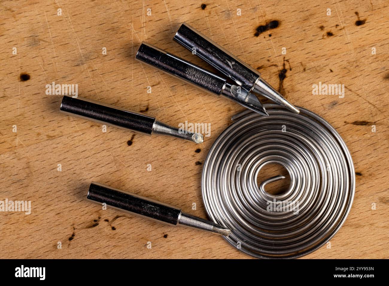 solder and soldering iron tips close up, twisted solder for repair work ...