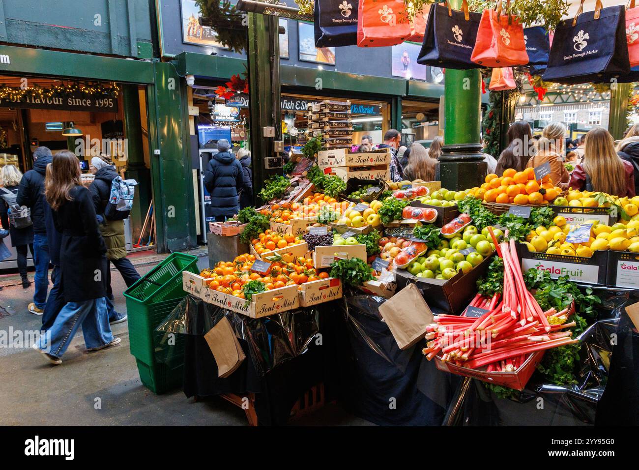 Shoppers in Borough market, a popular indoor food market in London, UK ...