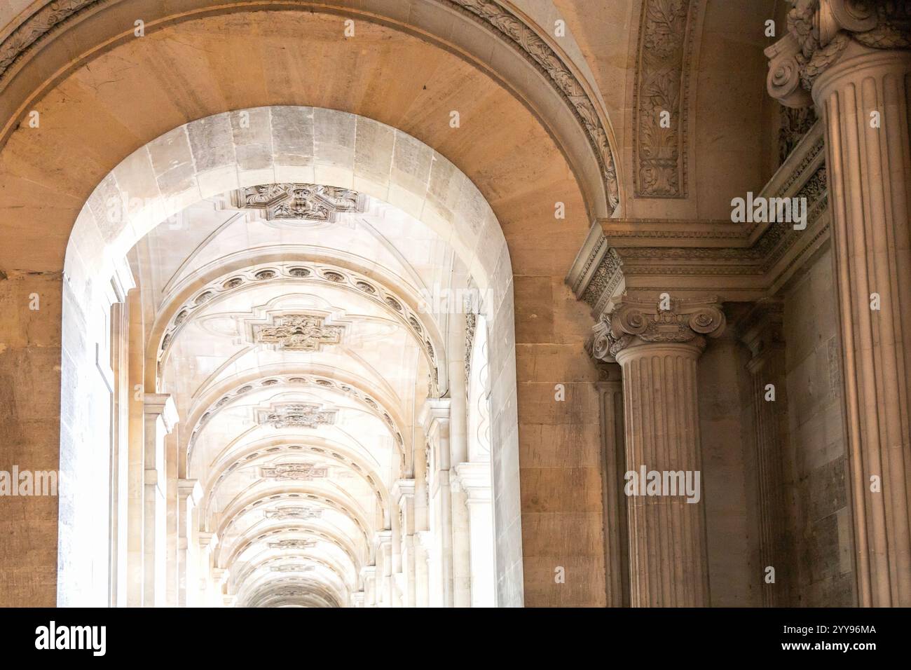 There is a beautifully designed long hallway featuring multiple arches and elegantly crafted ...