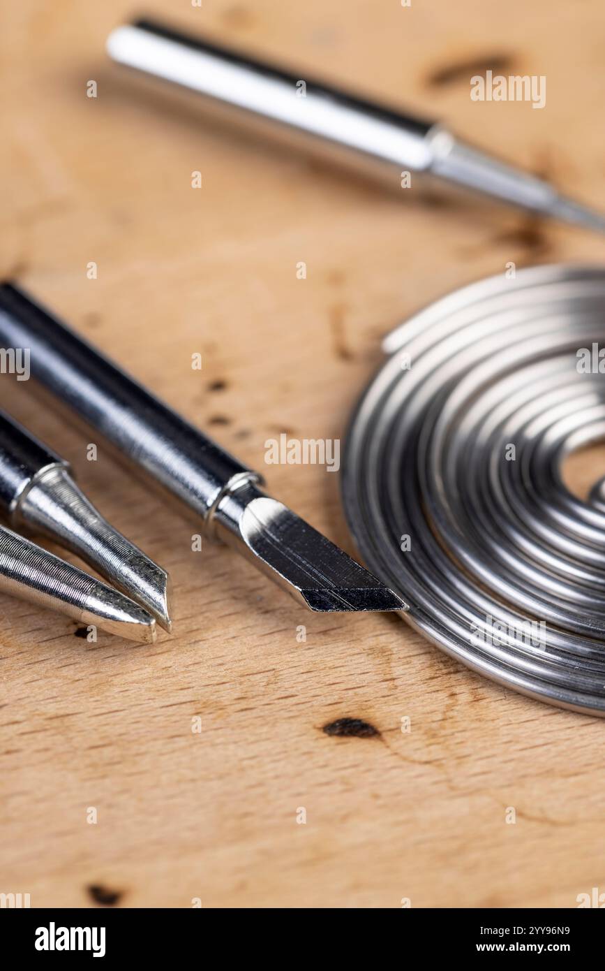 thin and soft solder and soldering iron tips, twisted as a spring ...