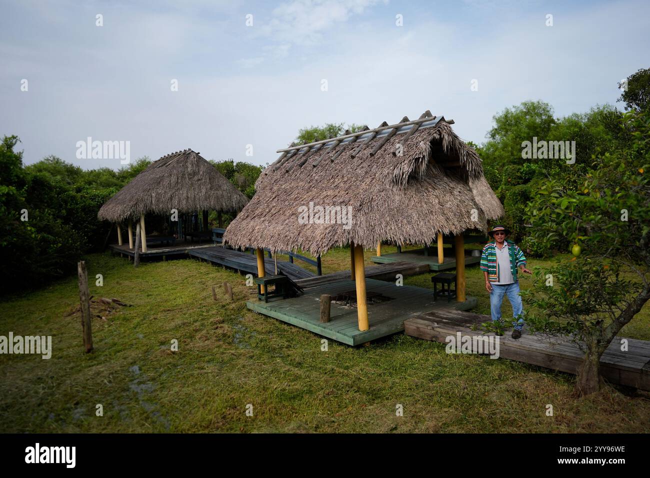 Miccosukee Tribal elder Michael Frank stands on raised walkways ...