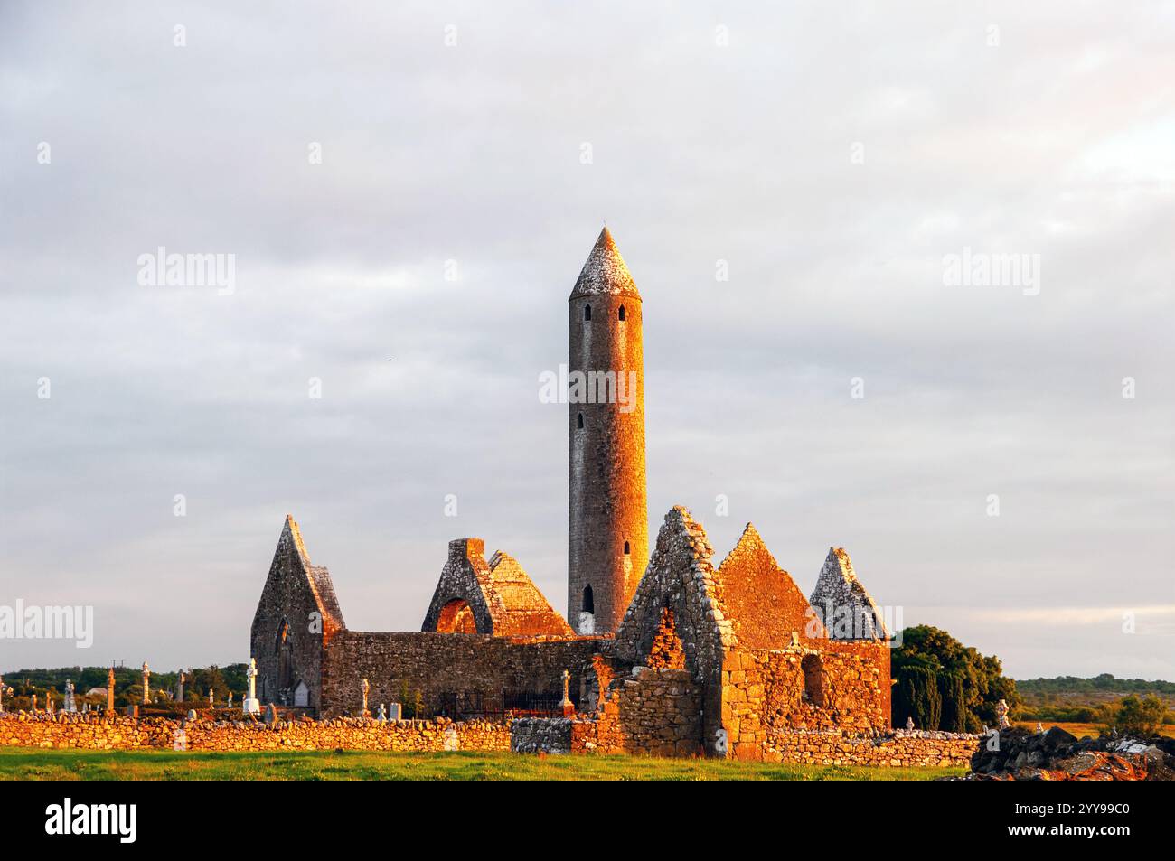 A large stone building with a tall tower. The building is old and has a ...