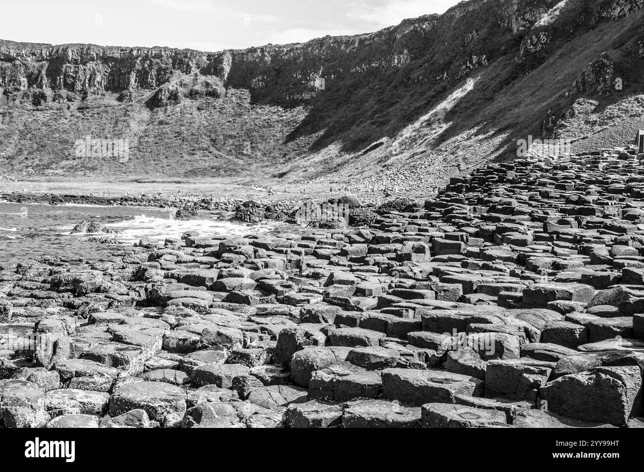A rocky landscape with a large hole in the middle. The rocks are large ...