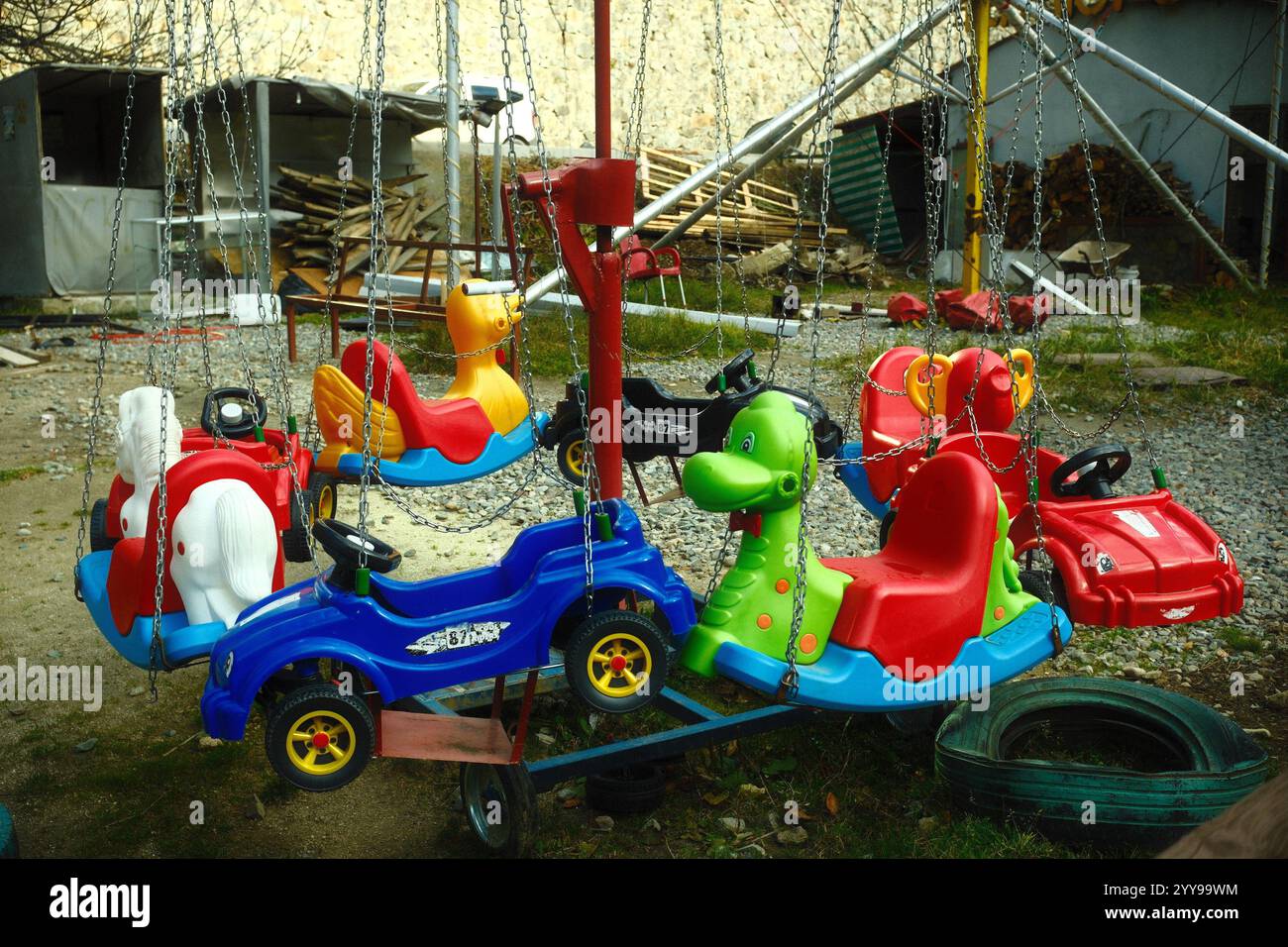 An abandoned and unmaintained kiddie carousel ride in a park that has ...