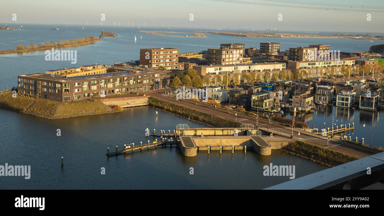 Overlook of floating residence and buildings in Amsterdam at sunset ...