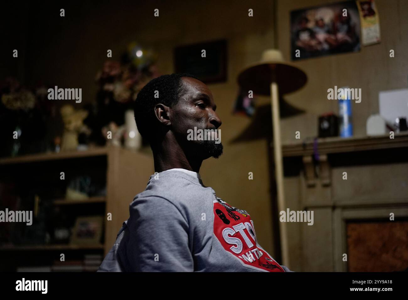 Tyrone Heard sits in his living room, Friday, Dec. 6, 2024, in ...
