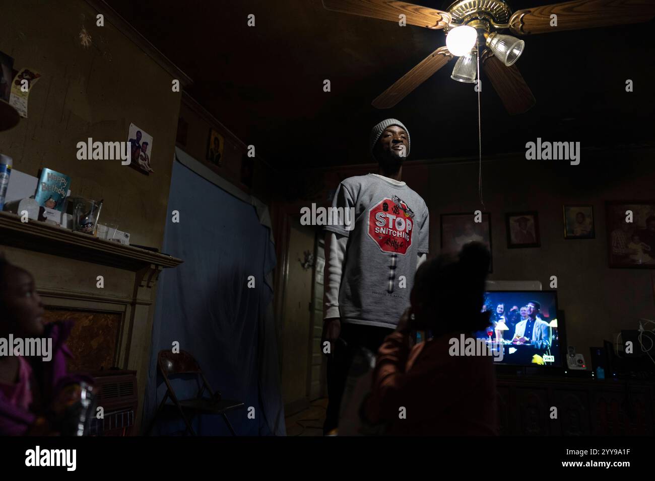 Tyrone Heard stands in his living room with his kids Karinina, 8 ...