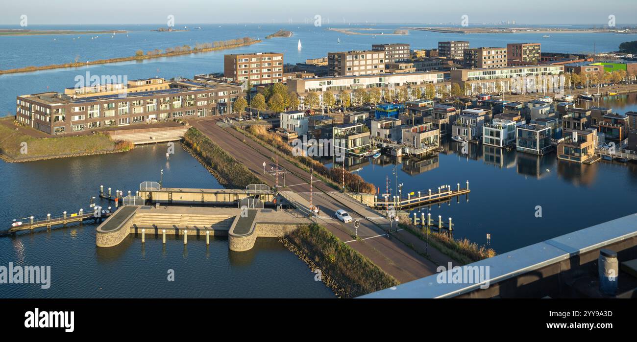 Overlook of floating residence and buildings in Amsterdam at sunset ...