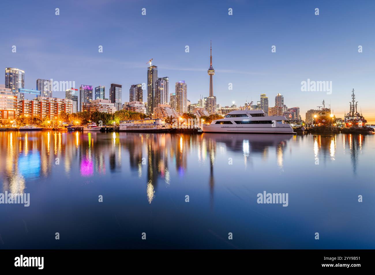 Toronto, Canada's beautiful skyline reflected in the calm harbor waters ...