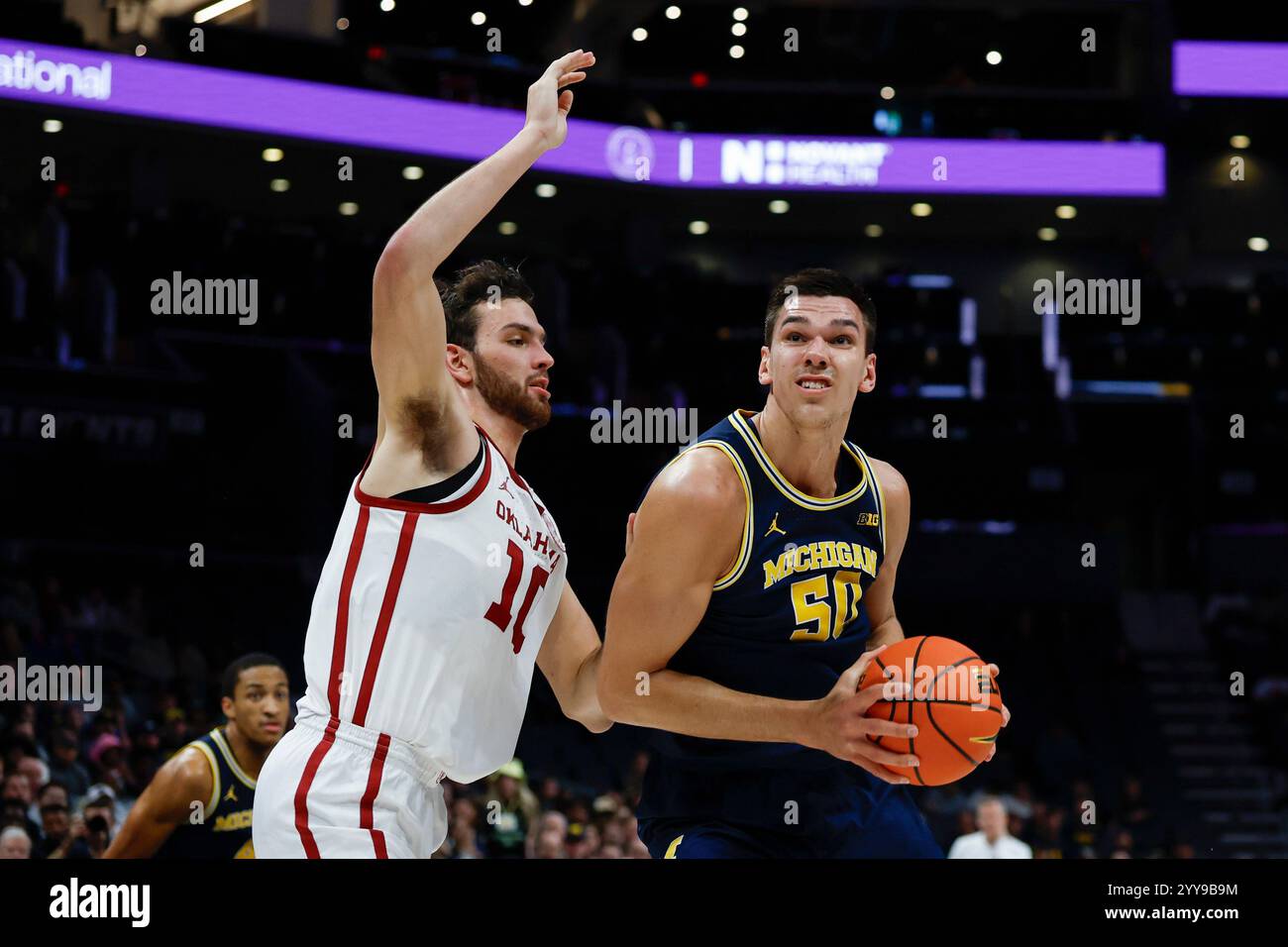 Michigan center Vladislav Goldin, right, looks to shoot against ...