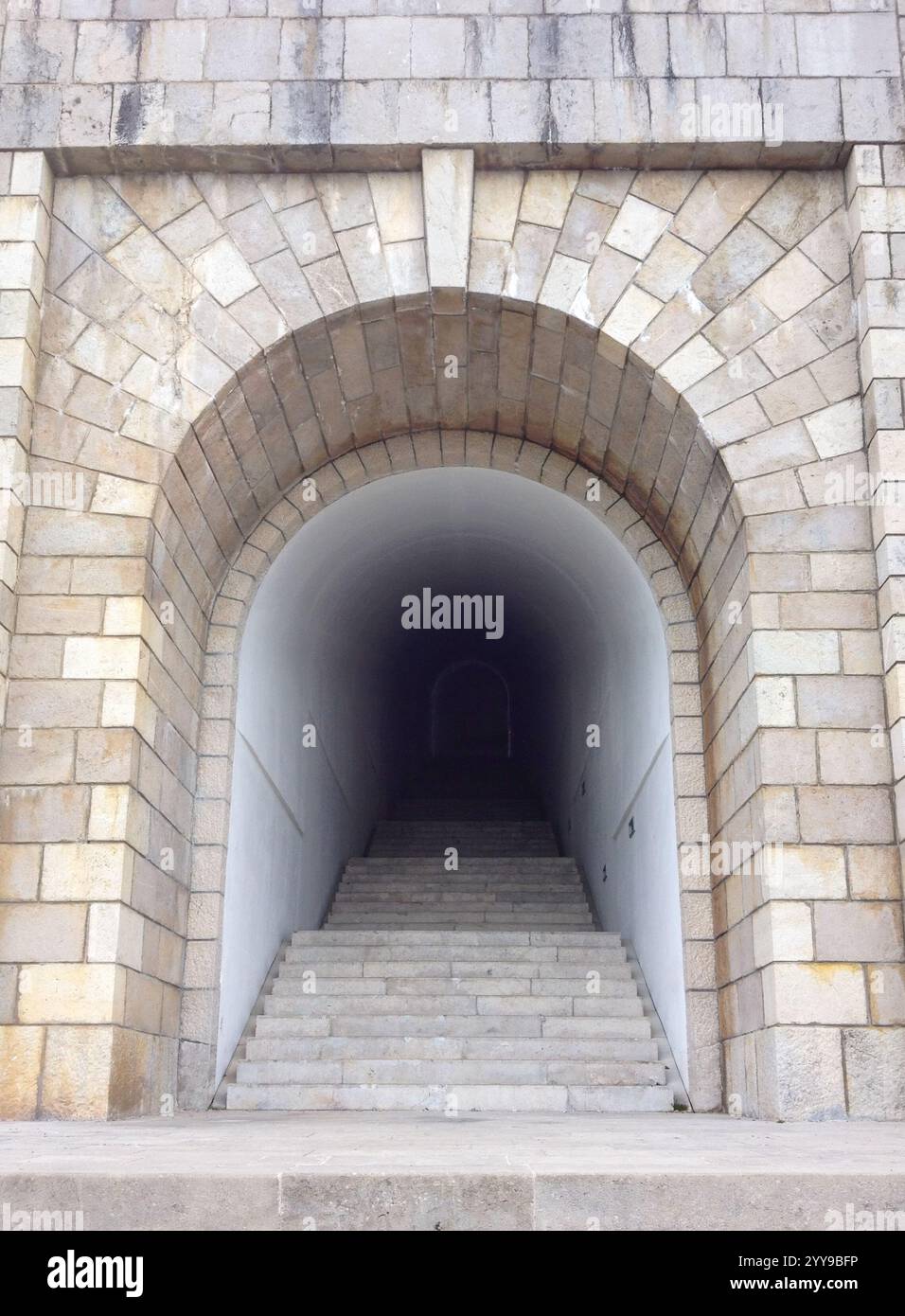 Arched stone tunnel entrance to Mausoleum of Njegoš with steps ...