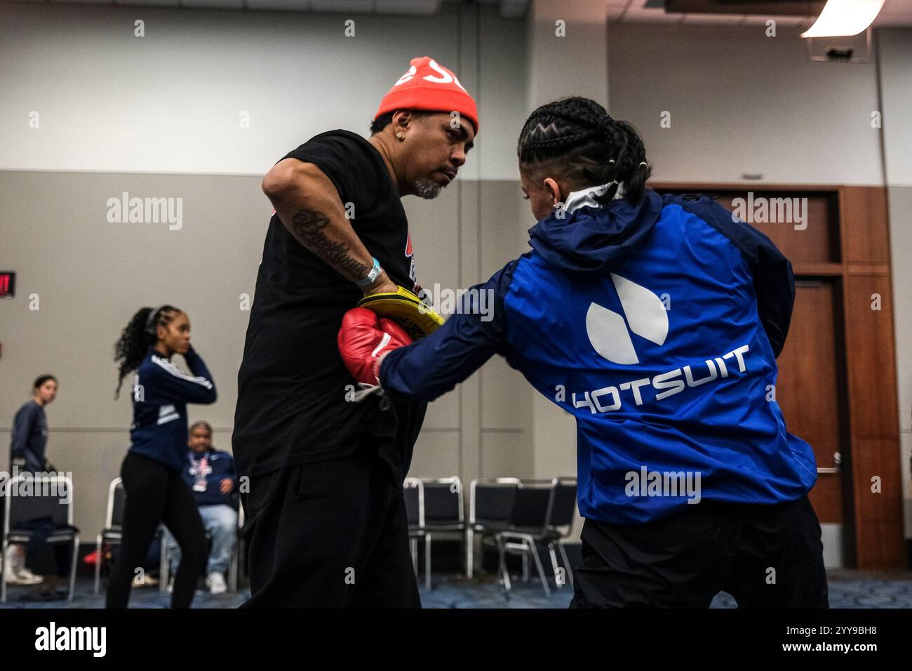 January 18, 2024, Richmond, Virginia, USA: A coach warms up his fighter ...